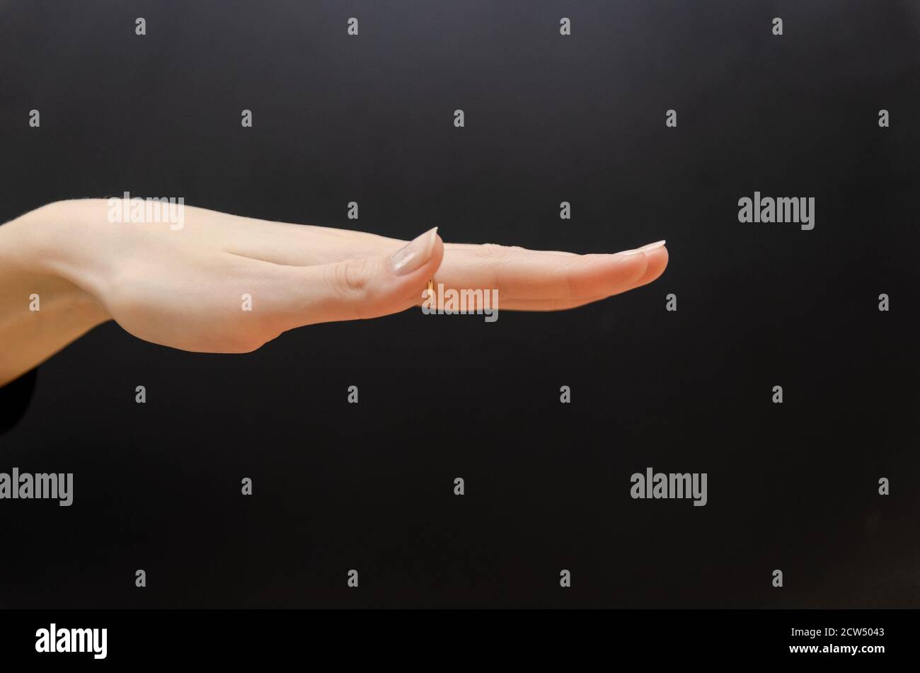 inverted female palm on a black background Stock Photo - Alamy