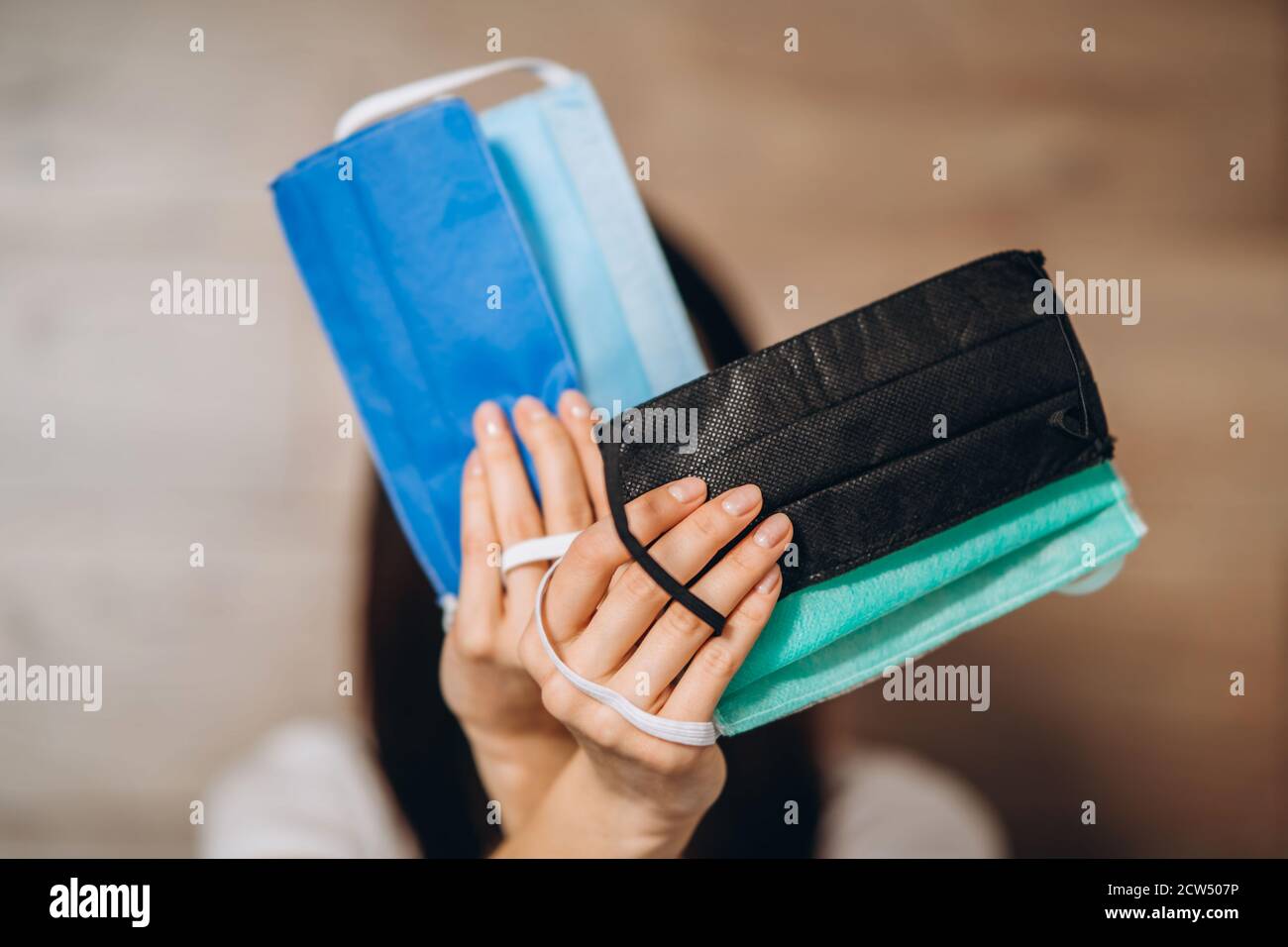 Female at home in quarantine time holding colorful protective medical ...