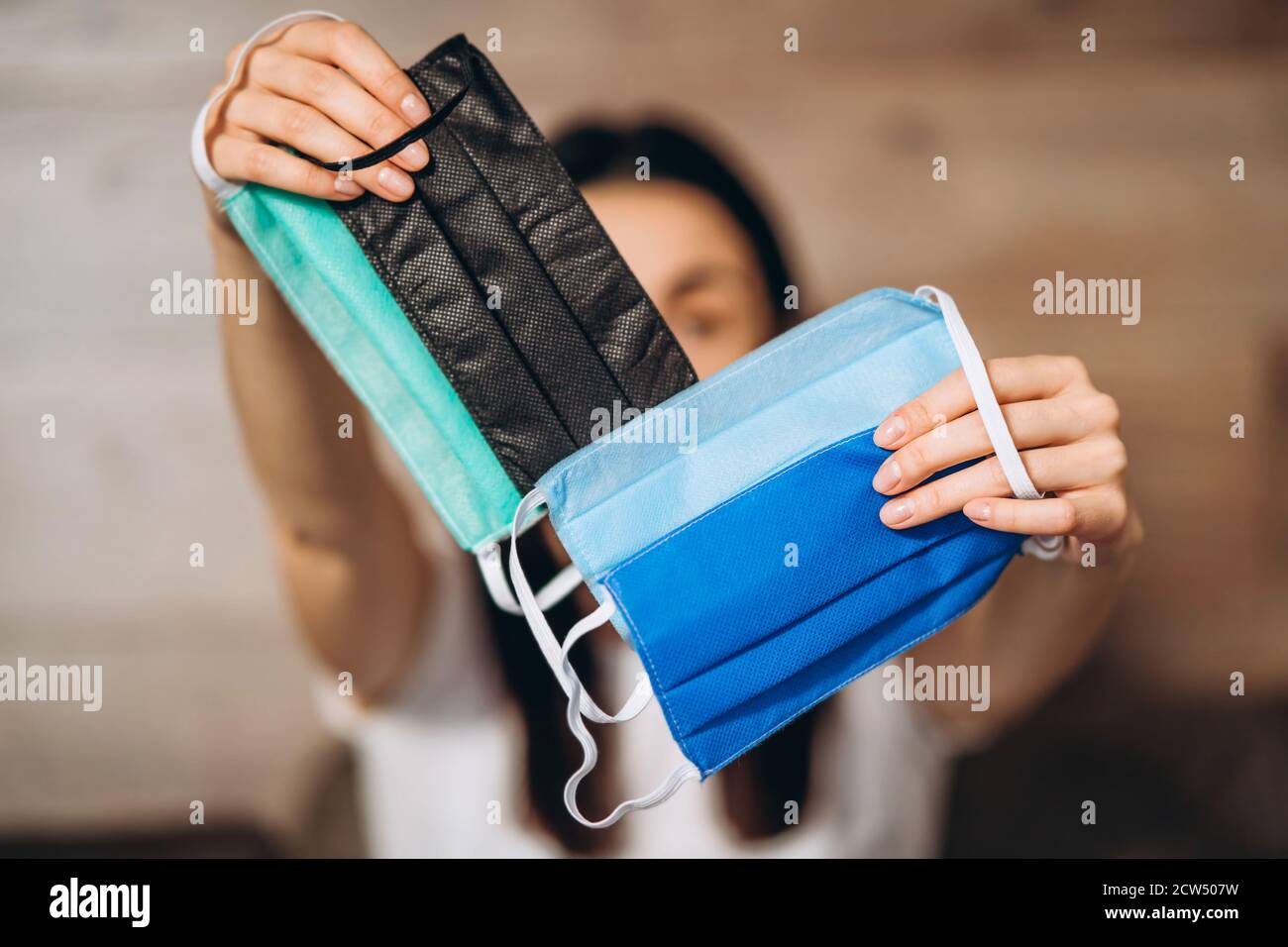 Female at home in quarantine time holding colorful protective medical ...