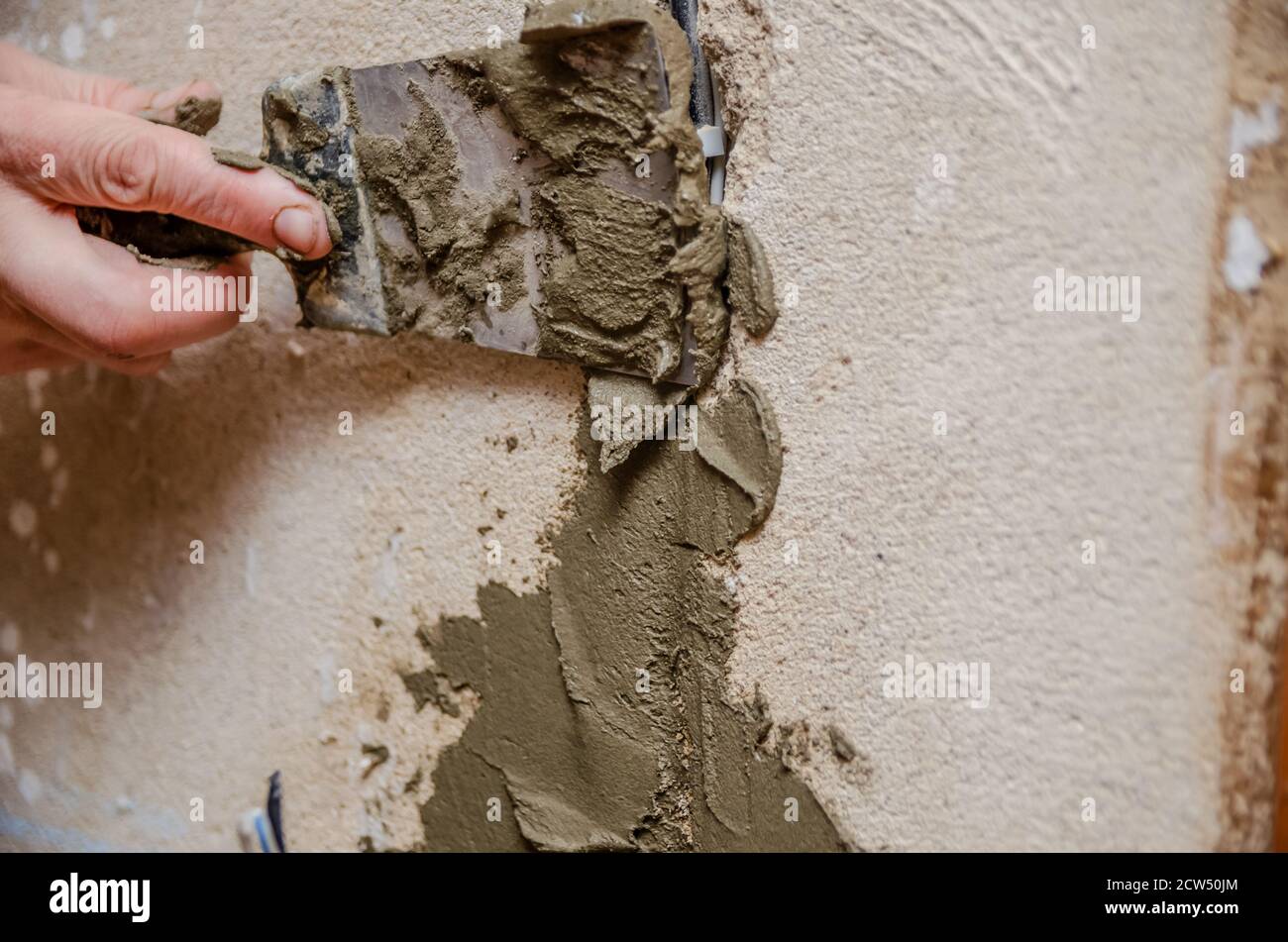 Technical hole in the wall with electrical wiring inside. Master with a ...