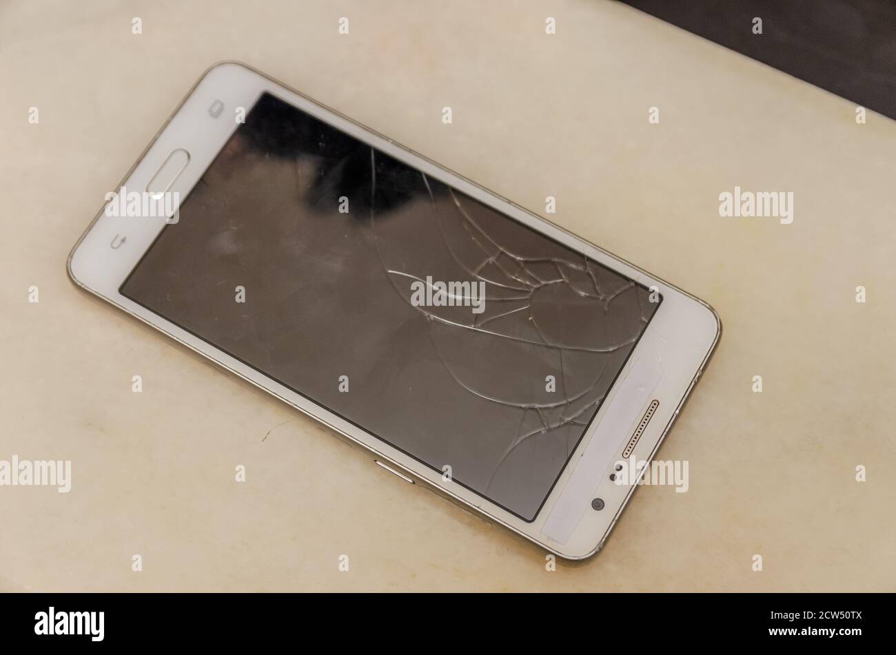 Smart phone with broken screen on dark background. Close-up Stock Photo ...