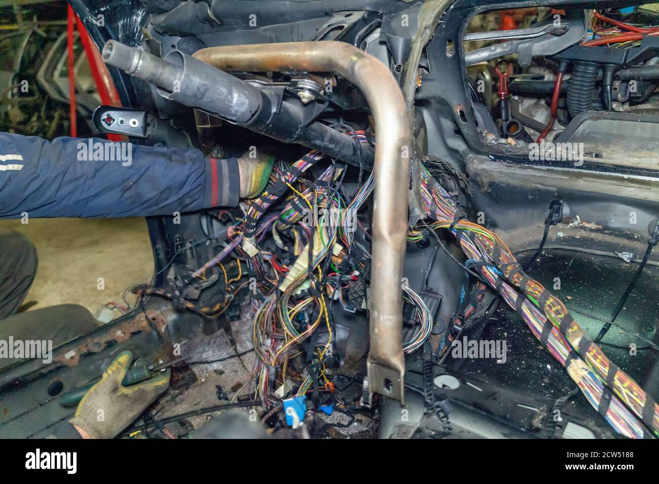 Mechanic electrician checking repairing upgrading wiring. Auto service ...