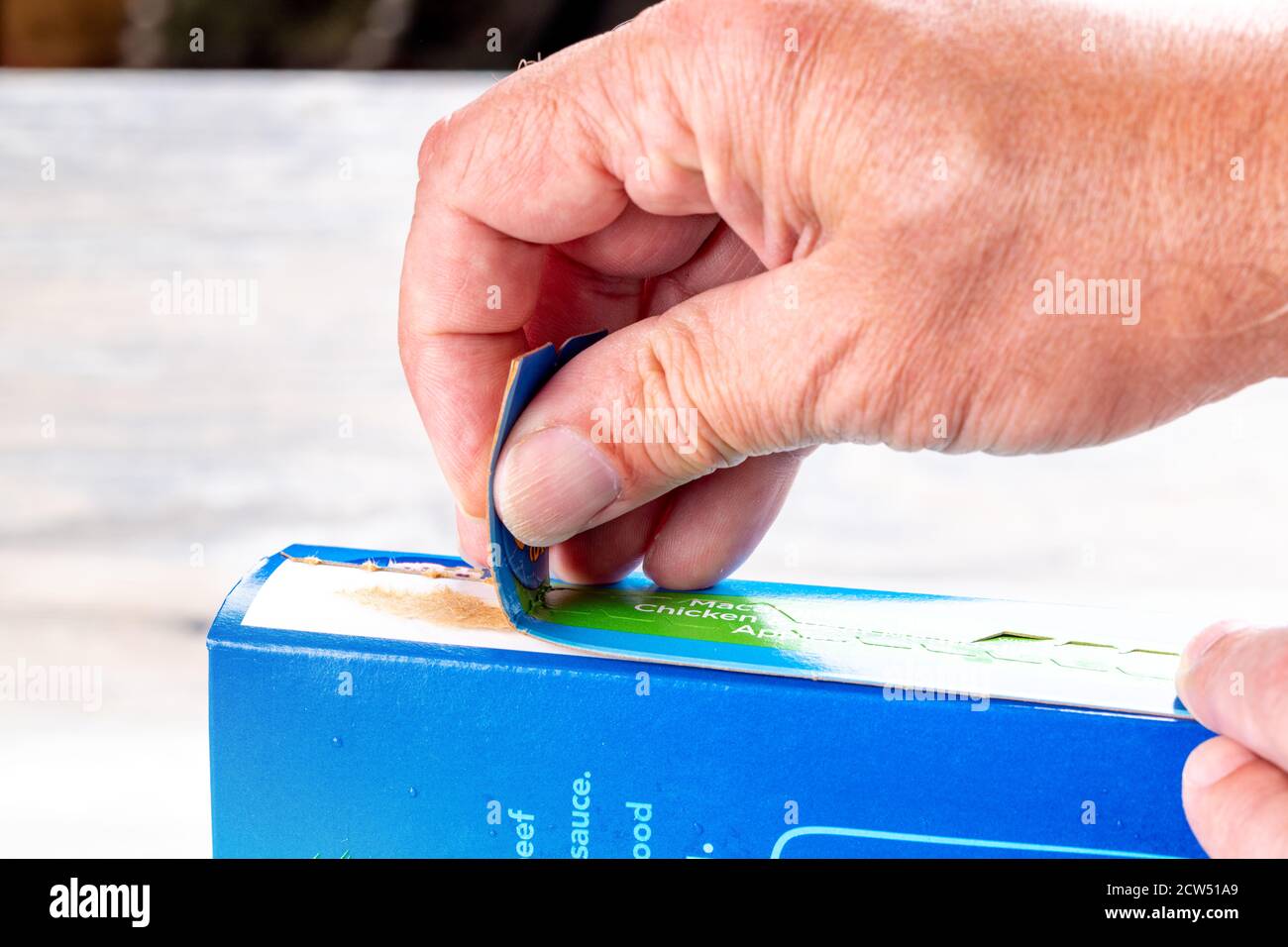 Cardboard carton with pull tab being removed Stock Photo - Alamy