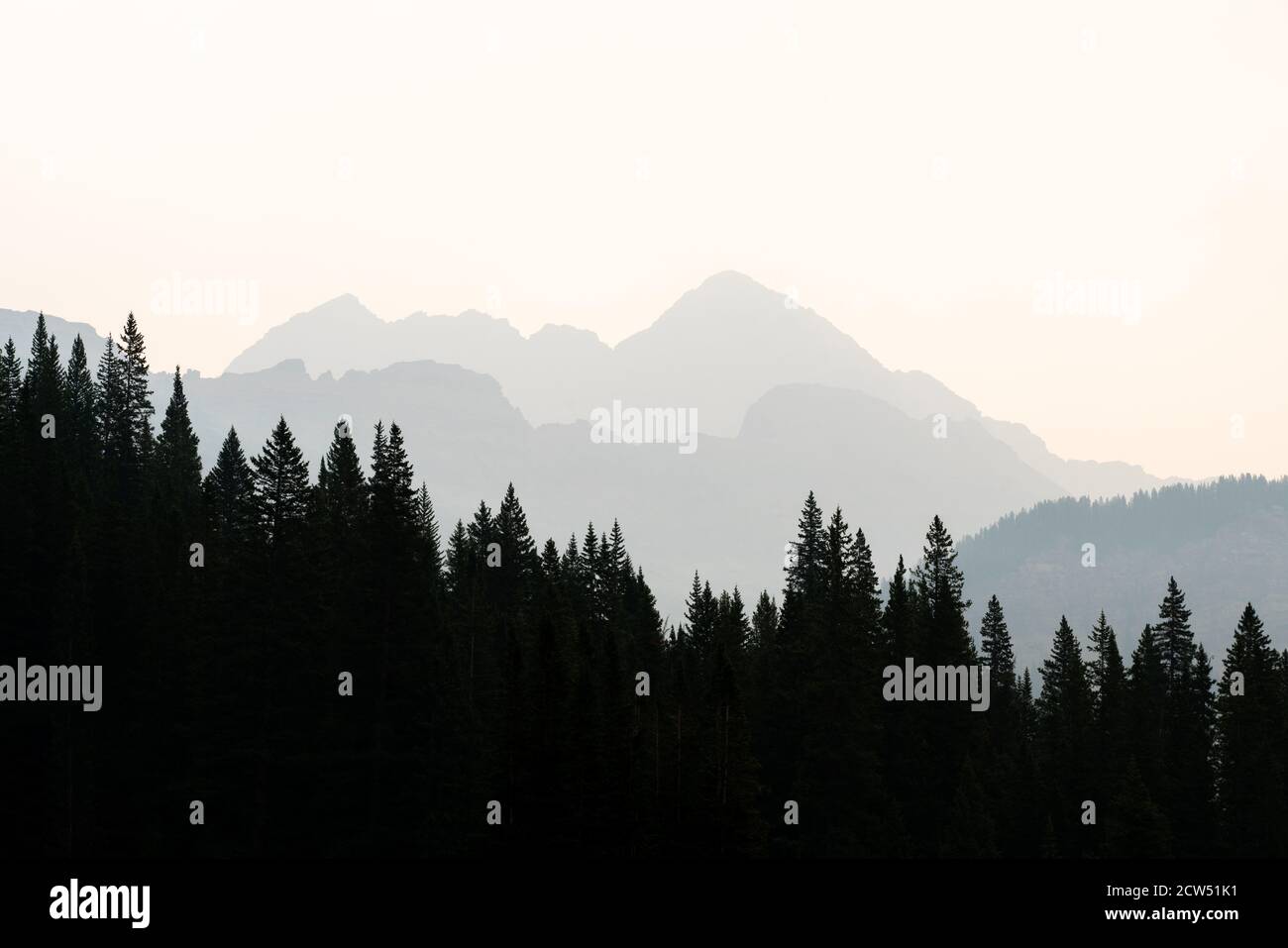 The serene Colorado mountains stand cloaked in a thick smoke haze, a ...