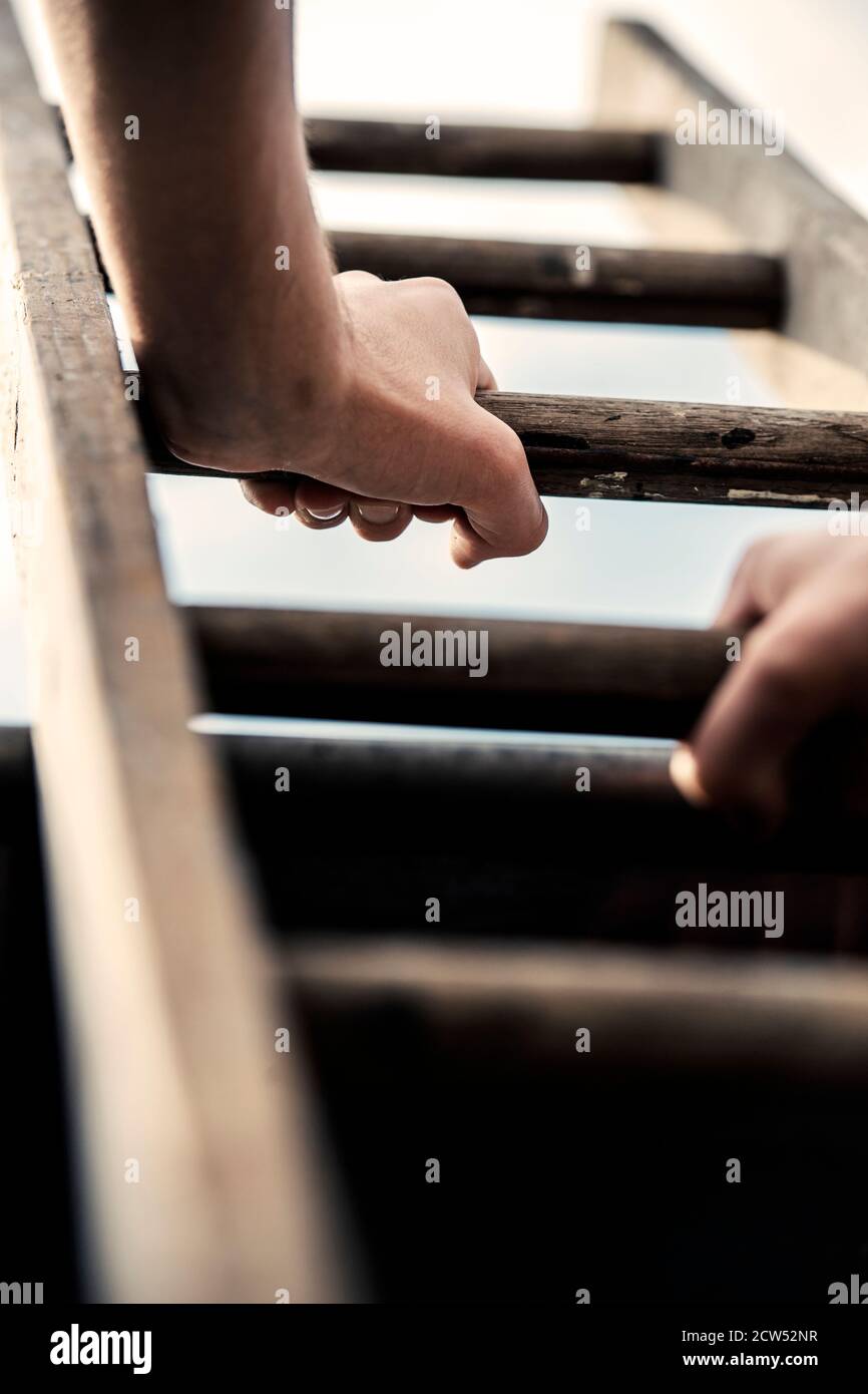 Person climbing a ladder hi-res stock photography and images - Alamy