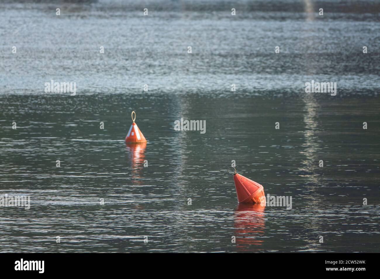 Bright red buoy in the middle of the sea surrounded by blue water Stock ...