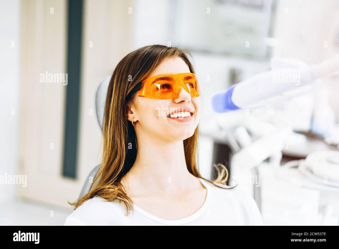 Teeth whitening procedure for pretty happy female patient in a dental clinic Stock Photo - Alamy