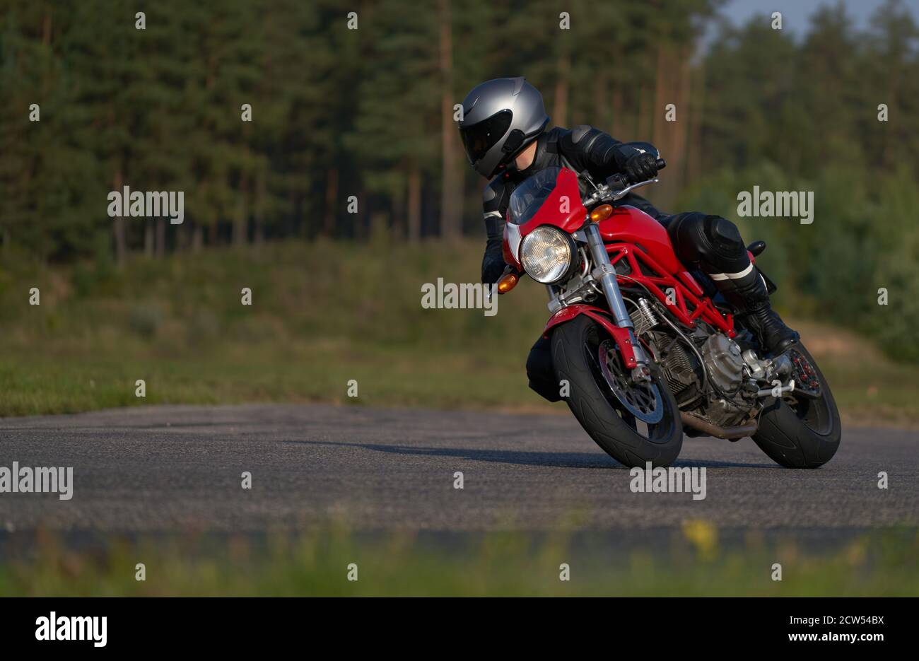 Handsome motorcyclist in black riding his super sport motorcycle Stock ...