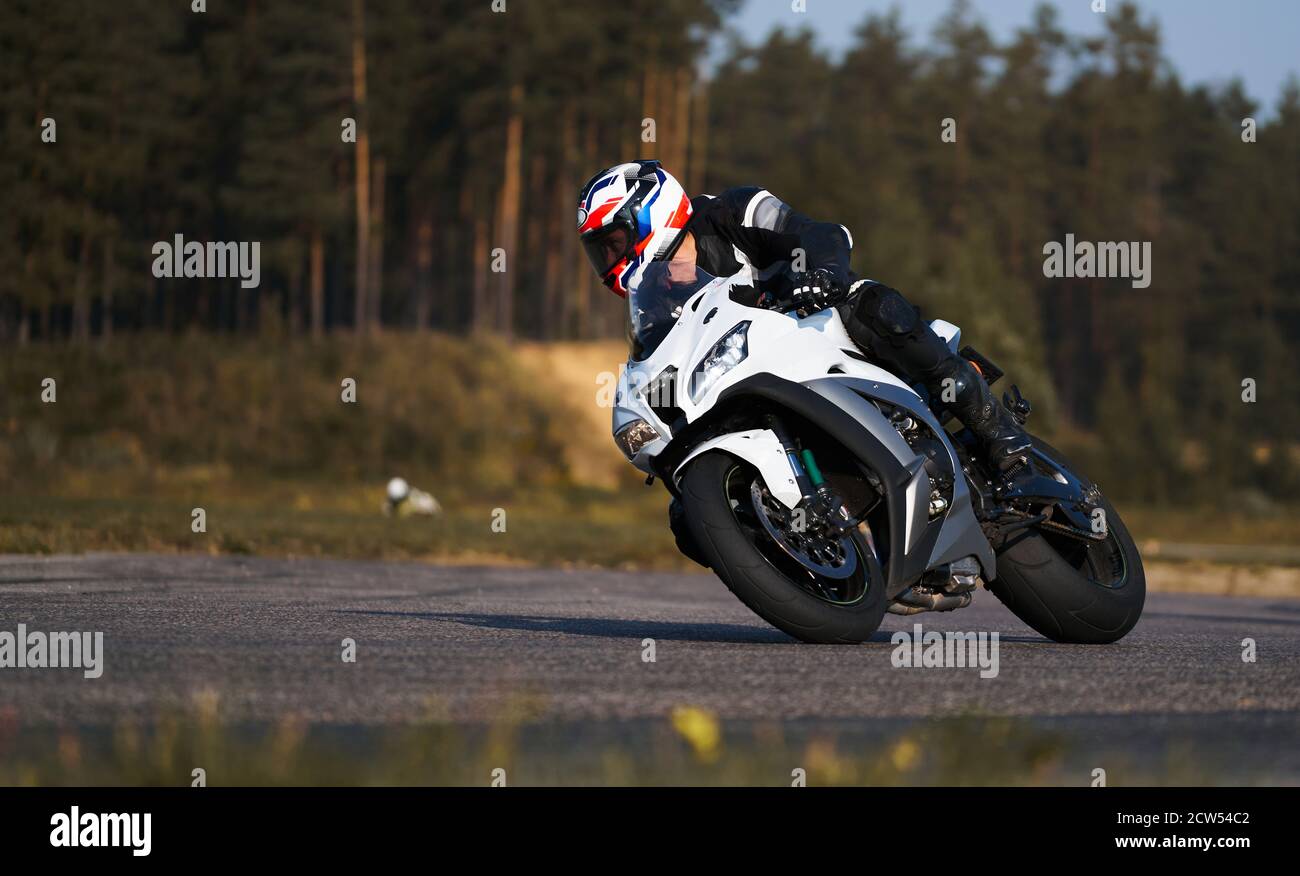Handsome motorcyclist in black riding his super sport motorcycle Stock ...