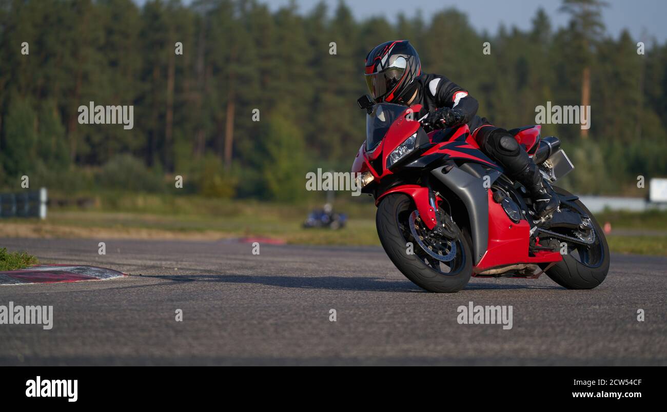 Handsome motorcyclist in black riding his super sport motorcycle Stock ...