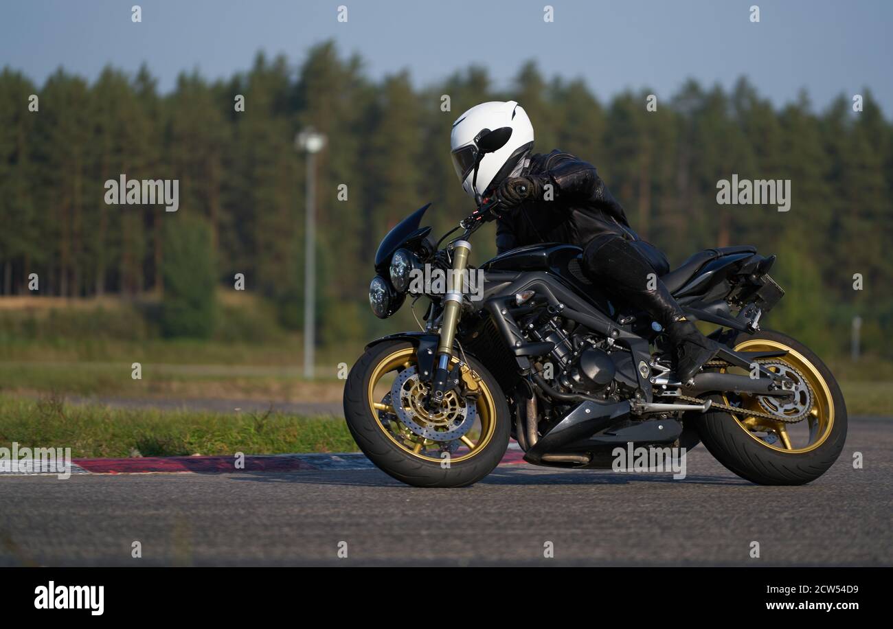 Handsome motorcyclist in black riding his super sport motorcycle Stock ...