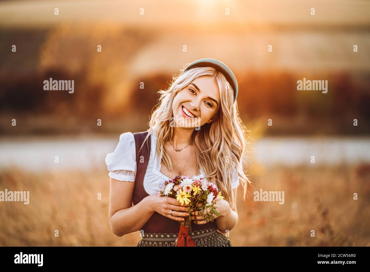 Pretty blonde girl in dirndl, traditional festival dress, standing ...