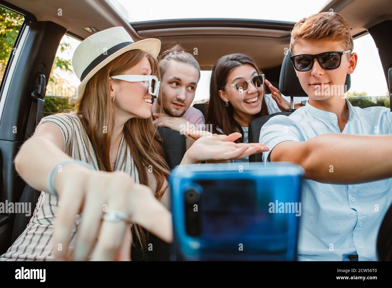 four friends in car navigation on phone Stock Photo - Alamy