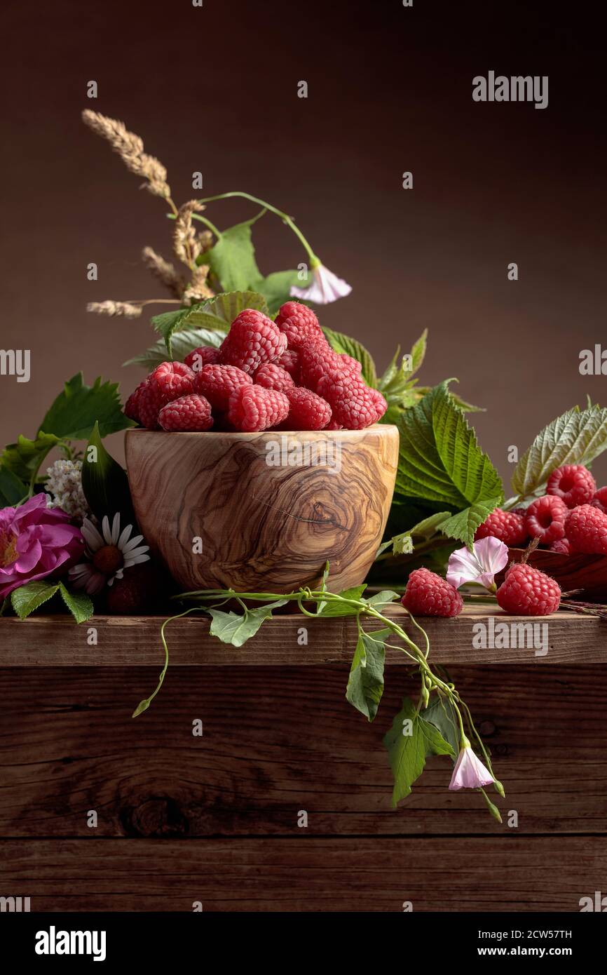 Fresh juicy raspberries in wooden bowl. Summer still life with ...