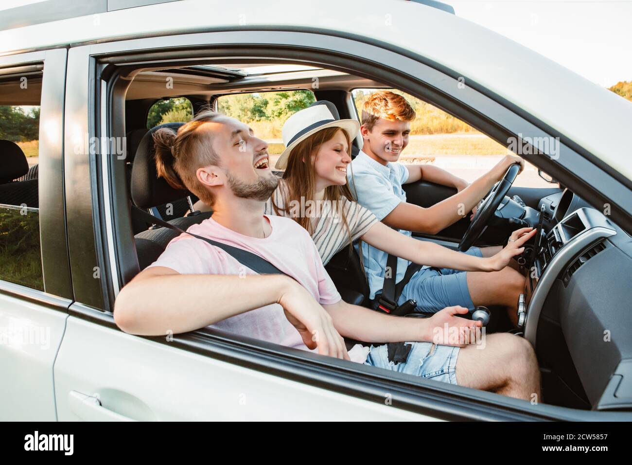 four friends in car navigation on phone Stock Photo - Alamy