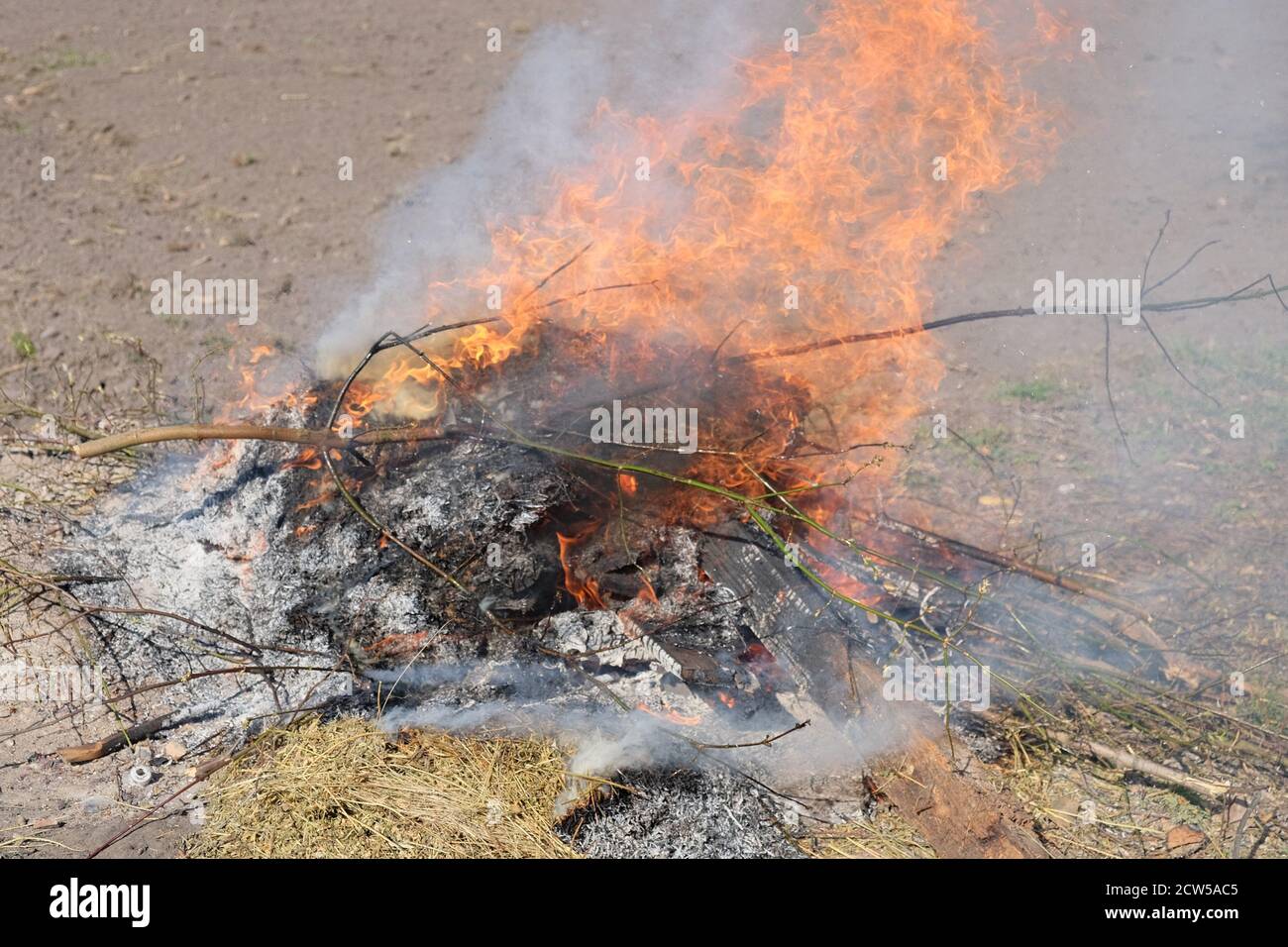 Big bonfire in the open air. A pile of ash from burnt boards and ...