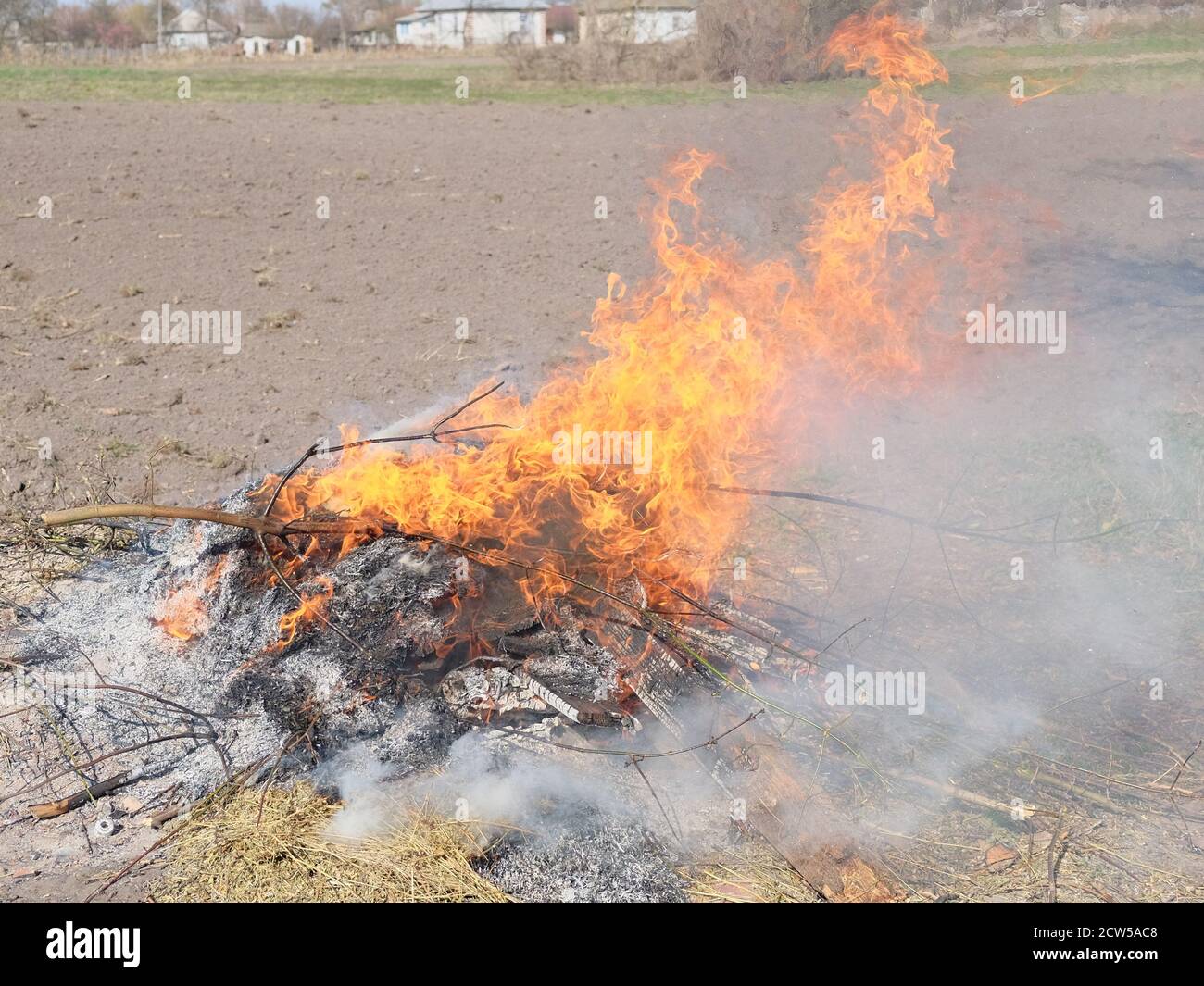 Big bonfire in the open air. A pile of ash from burnt boards and ...
