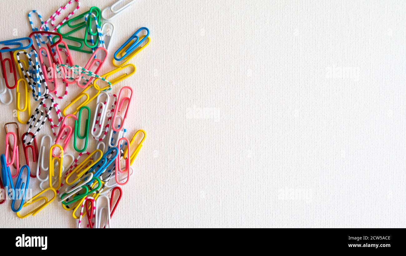 Colorful paper clips on a white background Stock Photo - Alamy
