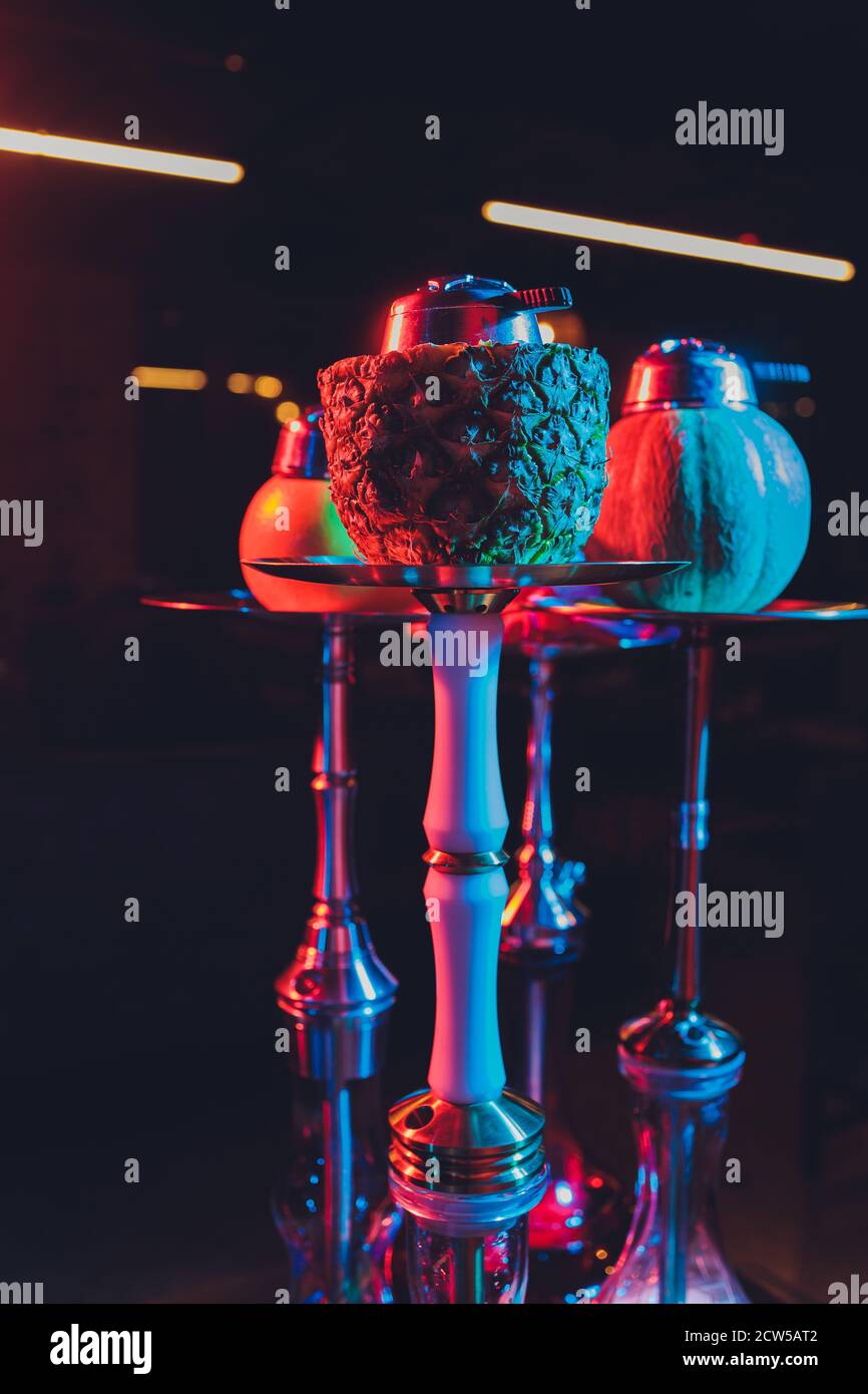 Red shisha hookah with smoke and red sparks on wood table brick, art ...