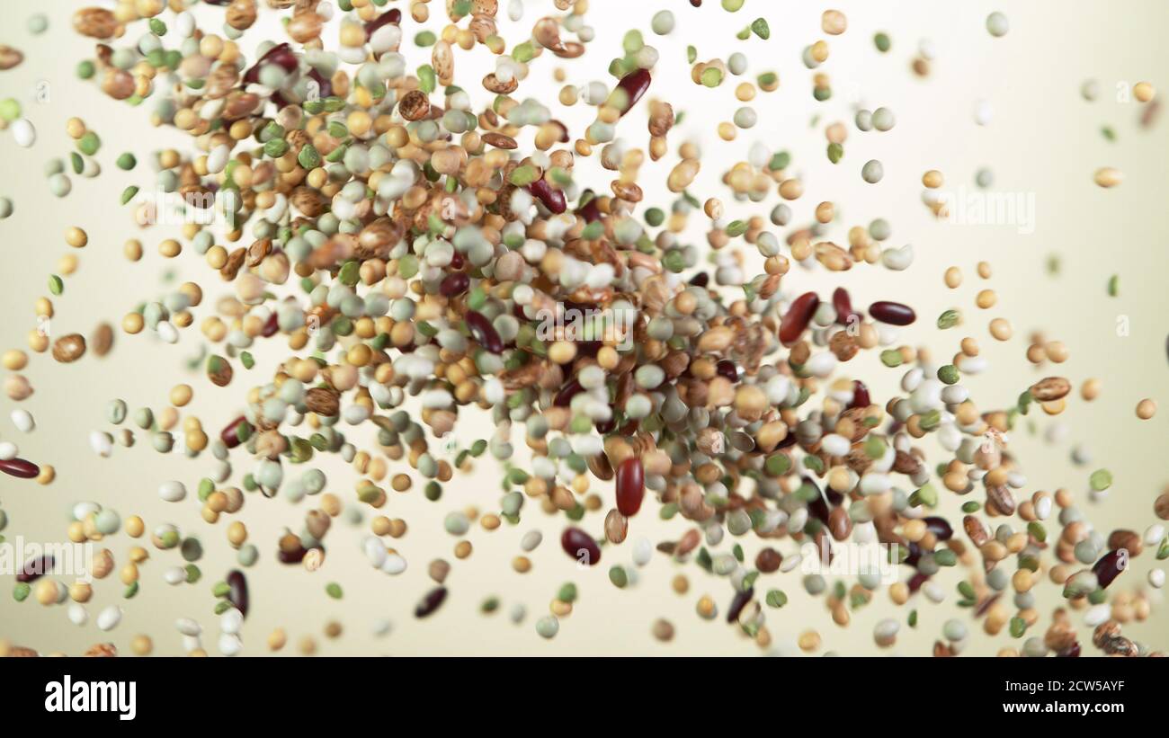 Legumes mix pieces hitting up in the air, isolated on white background ...