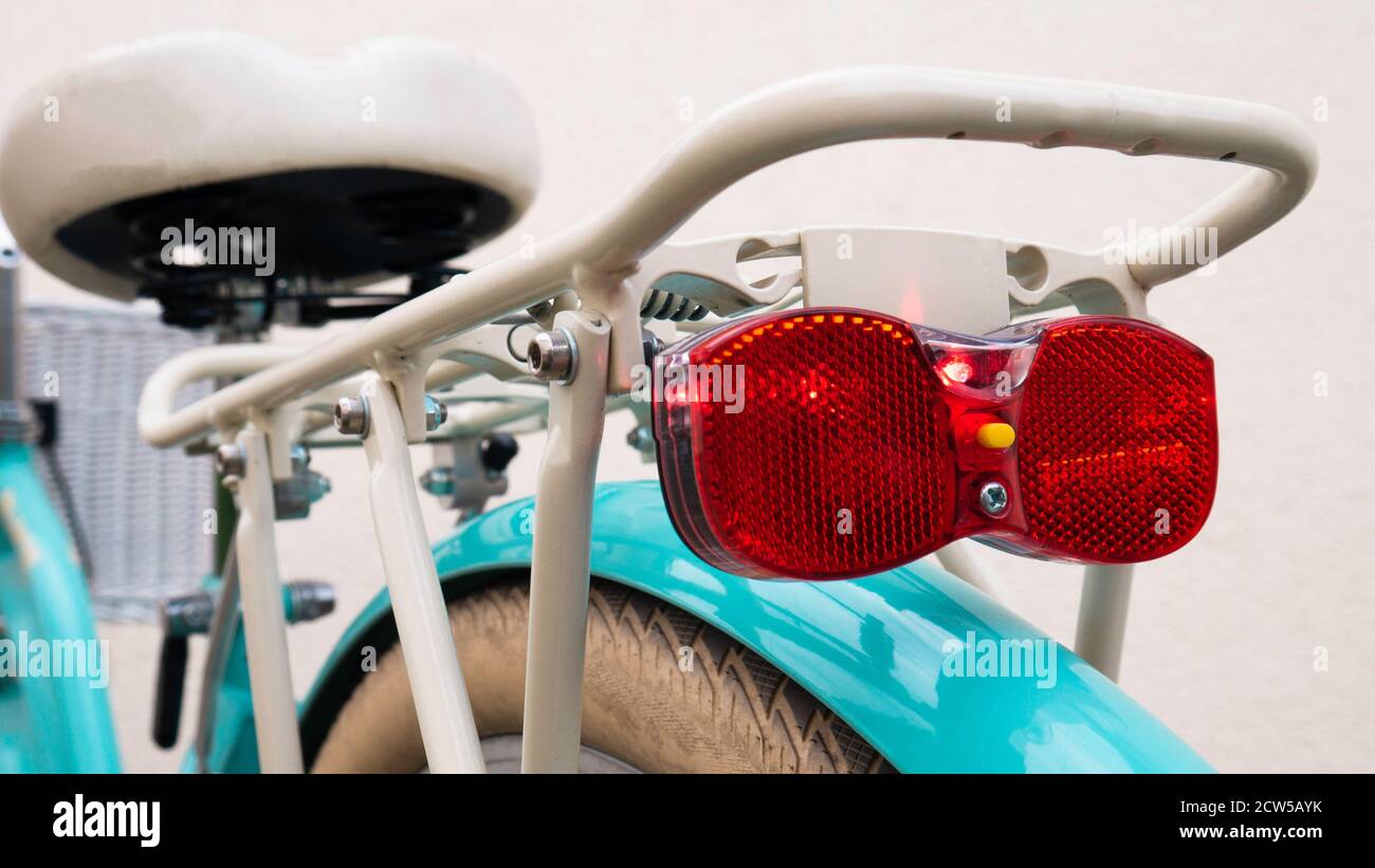 Red bicycle rear reflector and a rear wheel Stock Photo - Alamy