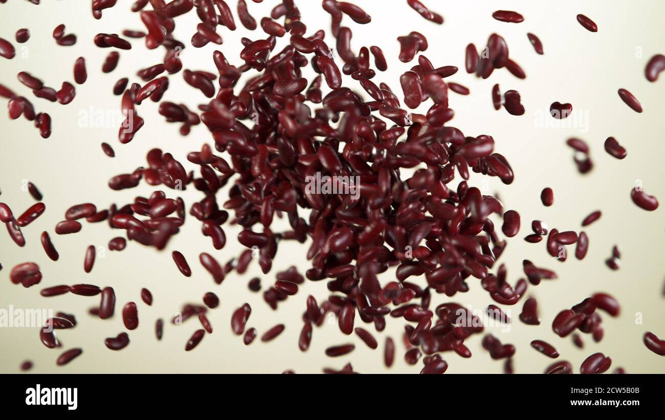 Raw red beans hitting up in the air, isolated on white background Stock ...