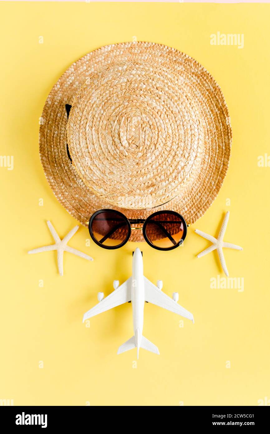 Tourist face made of straw hat, model plane, airplane and sunglasses on ...