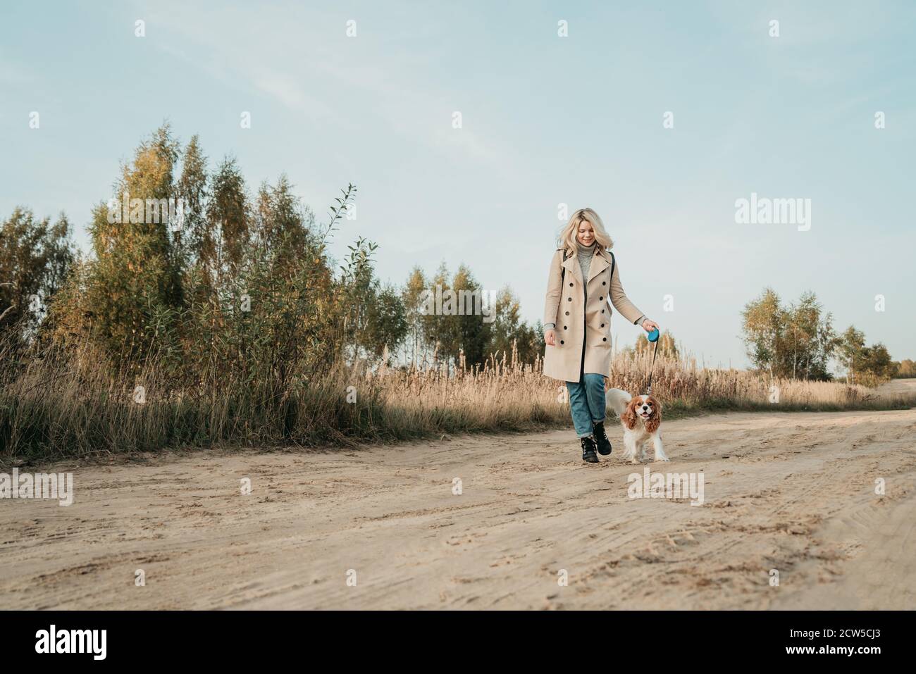 Travel with dog. Young woman walk with her cocker spaniel, backpack on ...