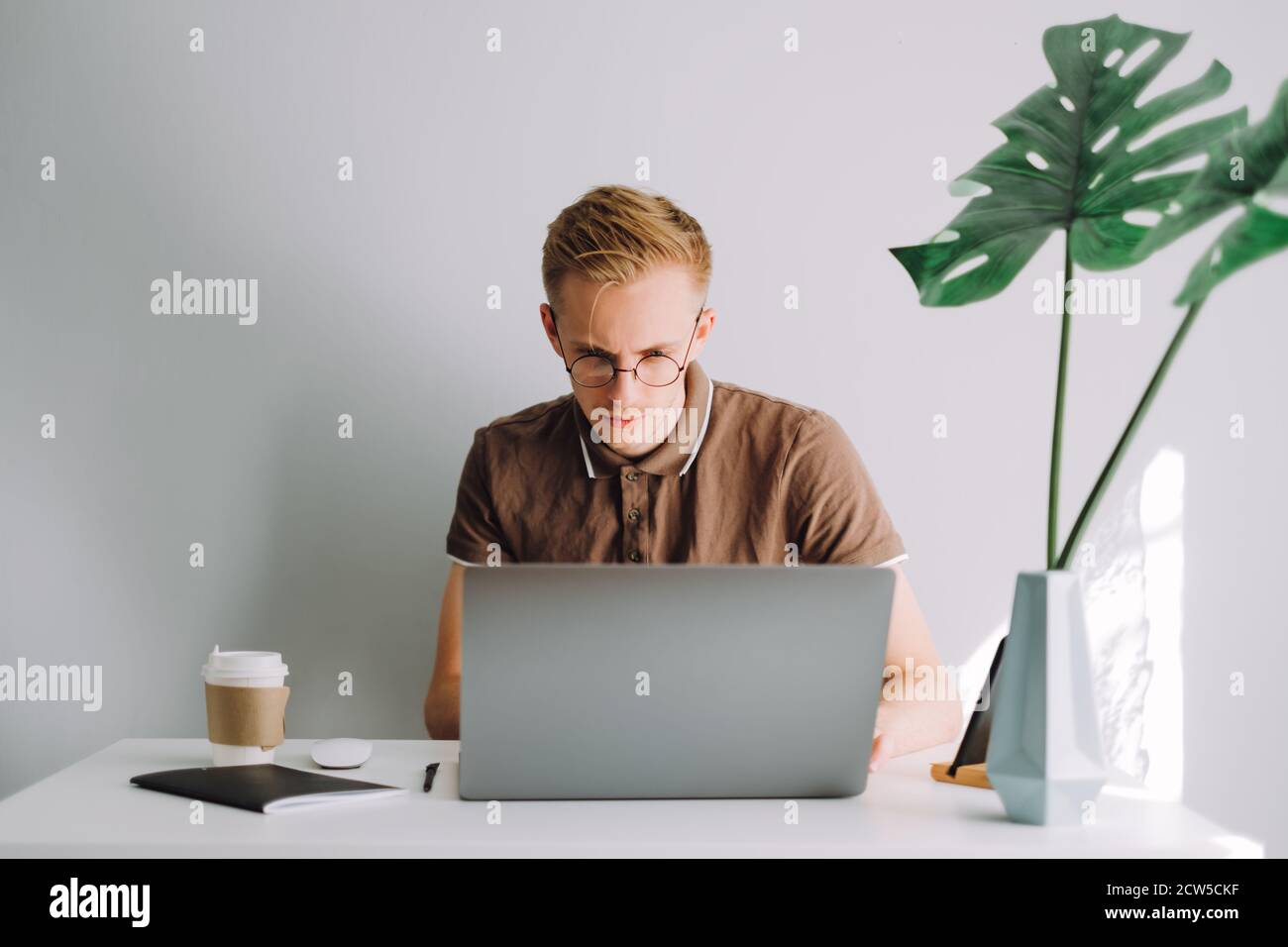 Focused man in glasses mobile developer, programmer writes program code ... Focused man in glasses mobile developer, programmer writes program code ...