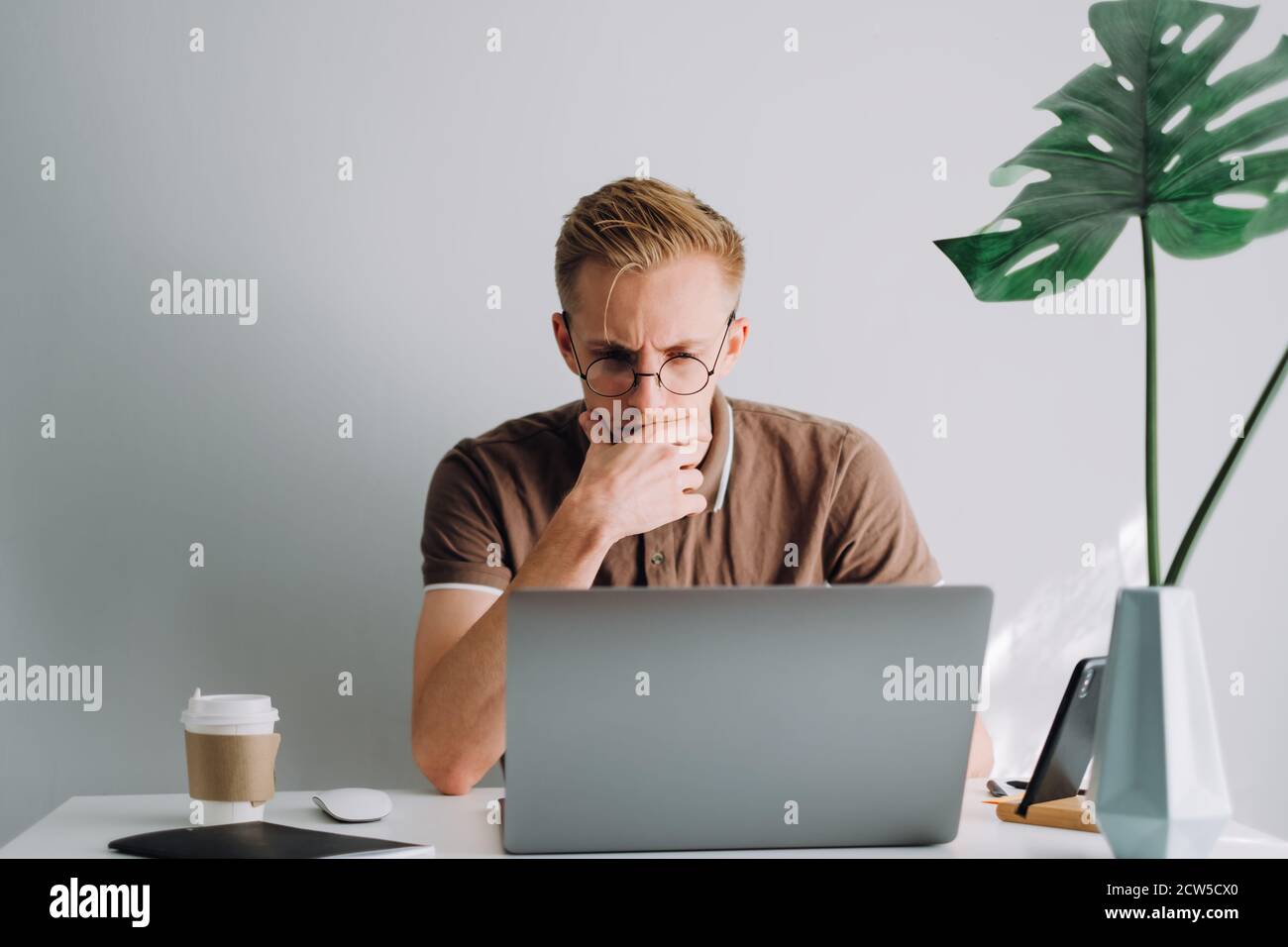 Pensive Man Mobile Developer Programmer Writes Program Code On A 9979