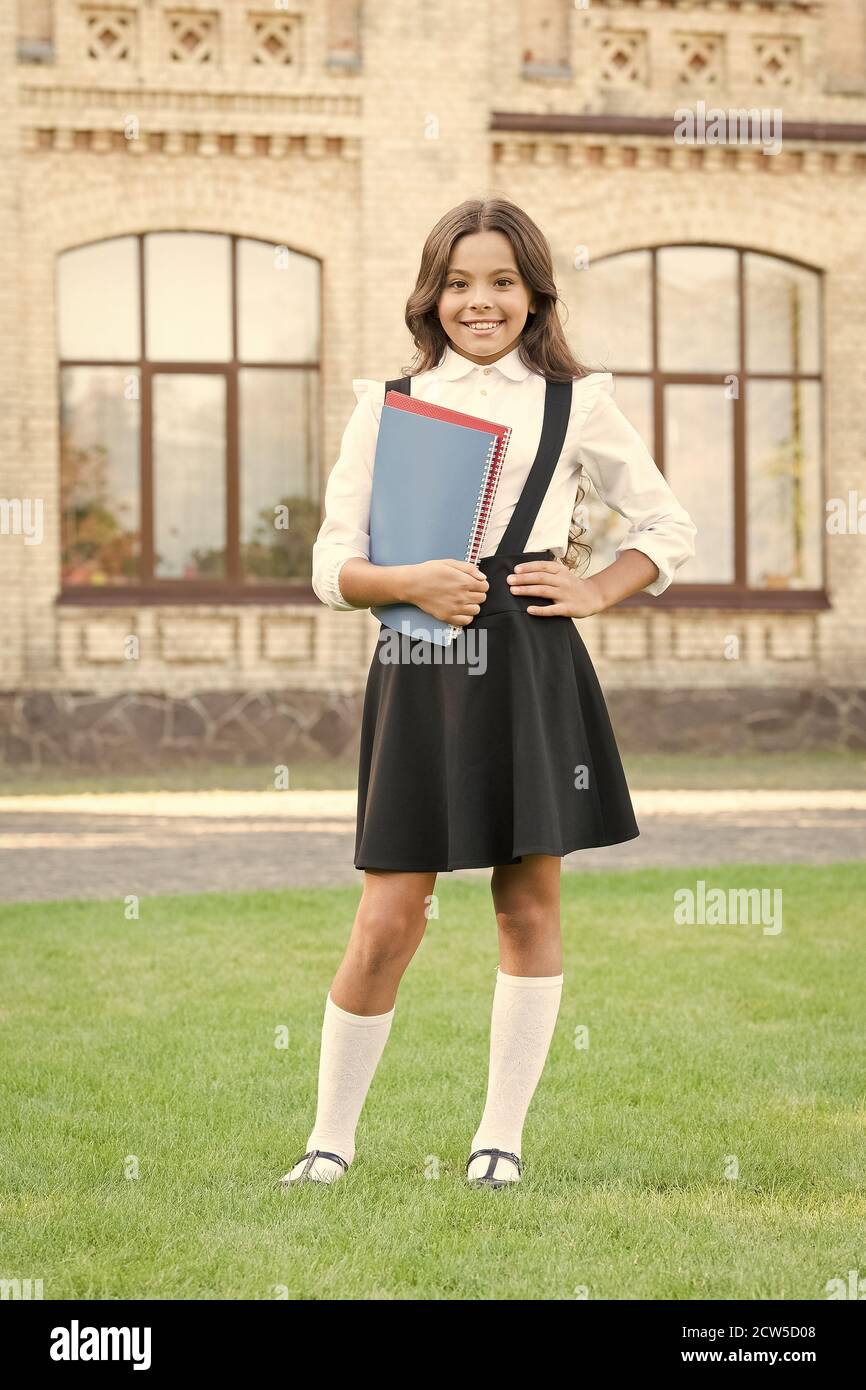 Start school year. Here we go again. Learning language. Cute smiling child hold book. Little ...