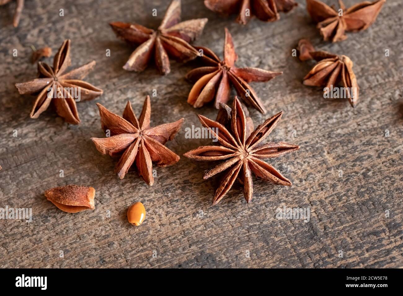 Star anise on a wooden table, closeup Stock Photo - Alamy