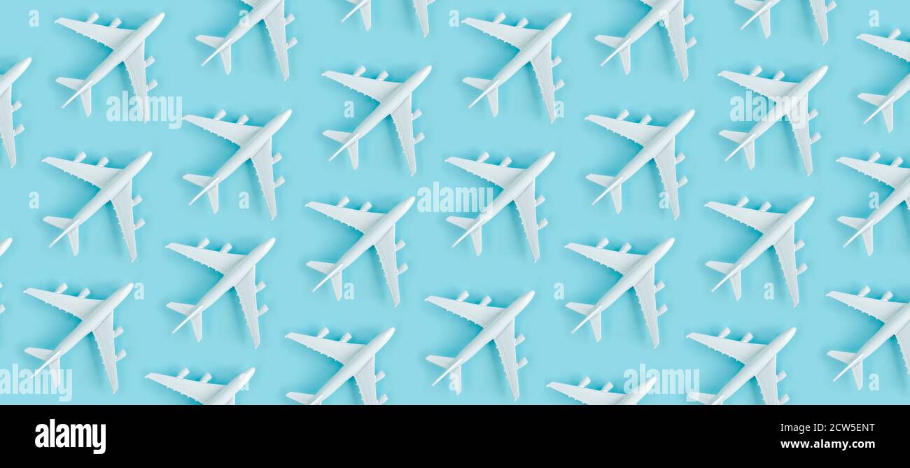White model plane, airplane on blue background. Top view, flat lay ...