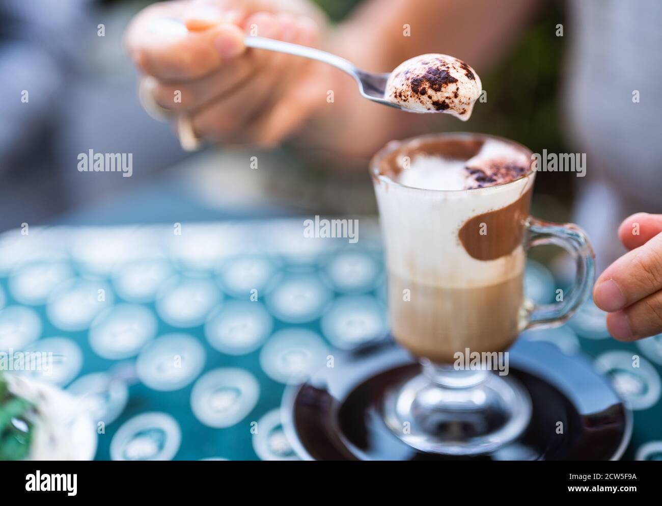 An inviting mocha: close-up shot on the spoon that raised the creamy ...