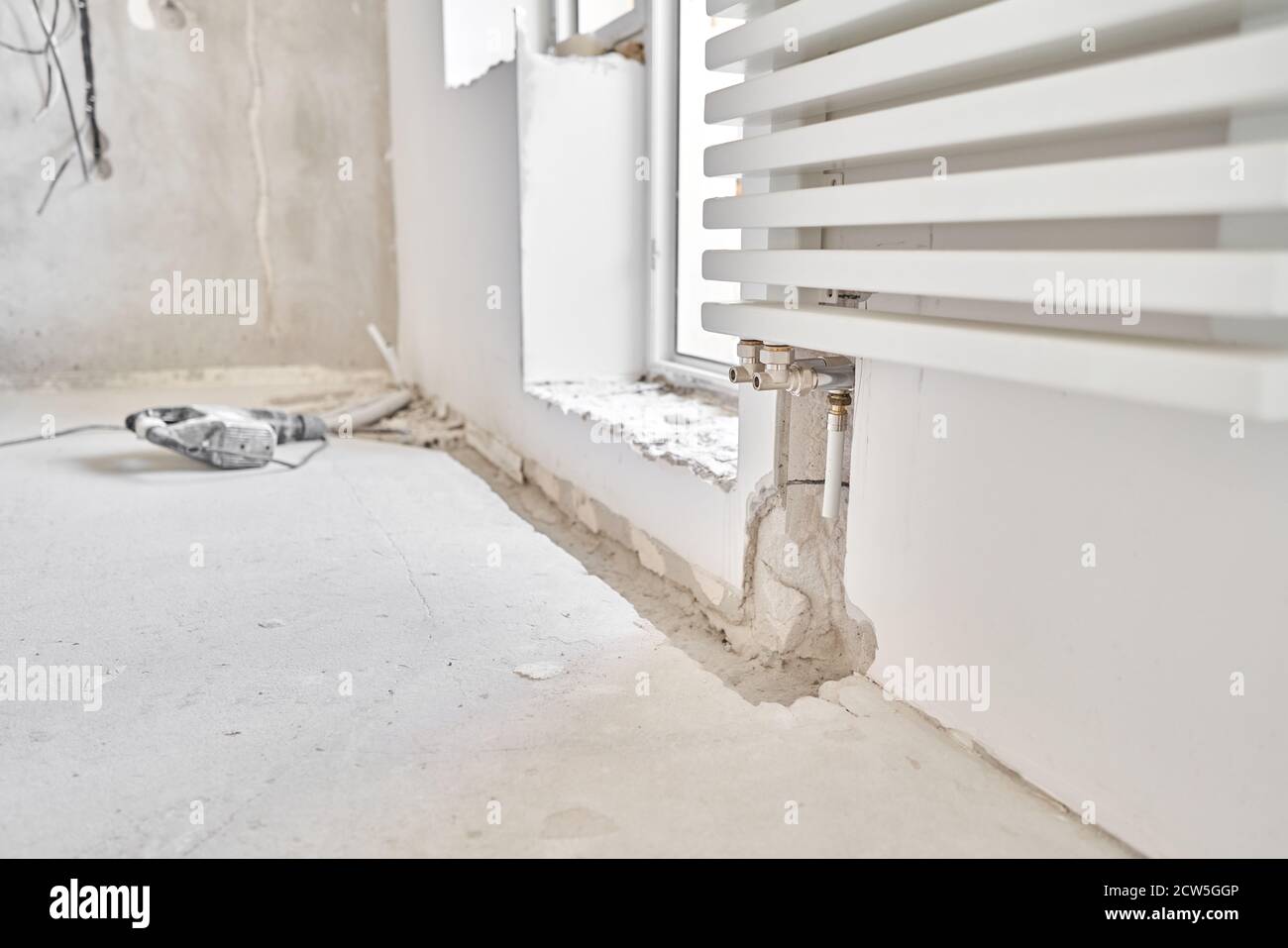 connection heating pipes to white Radiator in a new apartment under ...