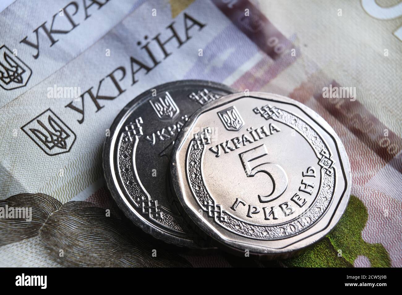 Ukrainian hryvnia coins placed on 100 UAH bills. New type of coins ...