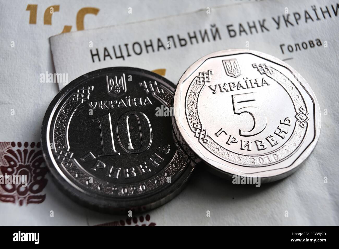 Ukrainian hryvnia coins placed on 100 UAH bills. New type of coins ...