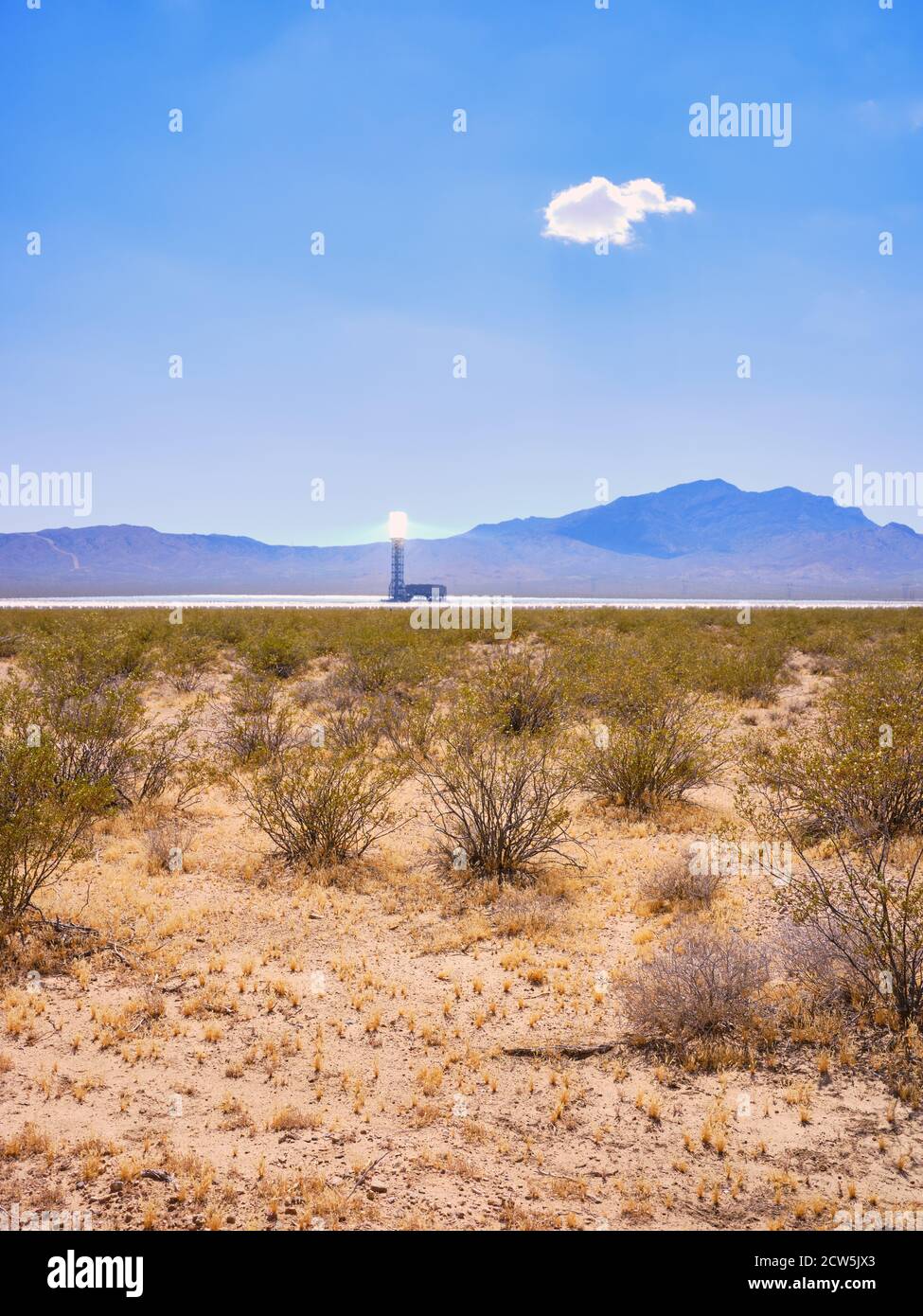 Solar tower reflects sun beams at solar farm, desert landscape cloud ...