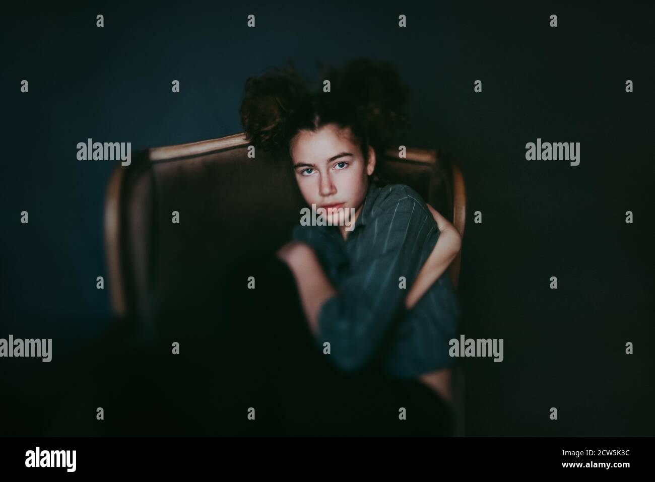 Girl sitting curled up hi-res stock photography and images - Alamy
