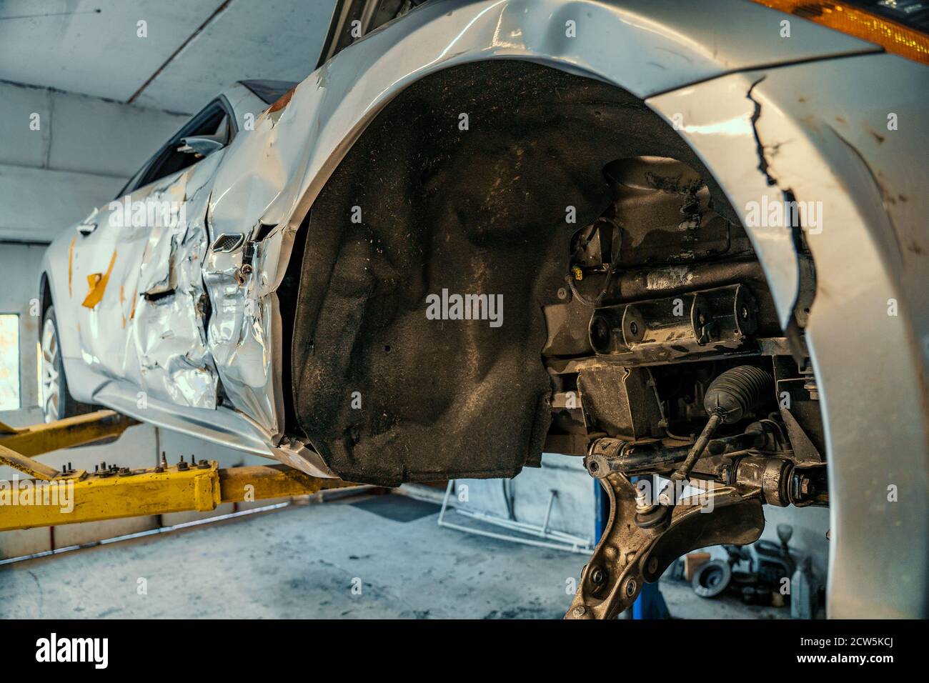 Broken or damaged sport car after road accident or crash in garage ...