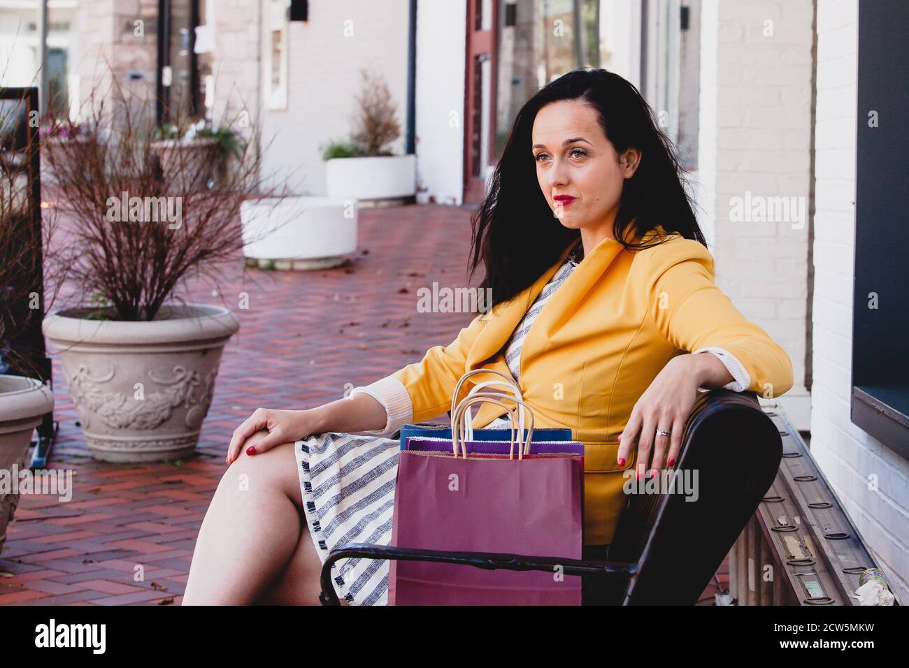 Beautiful woman sitting outside hi-res stock photography and images - Alamy