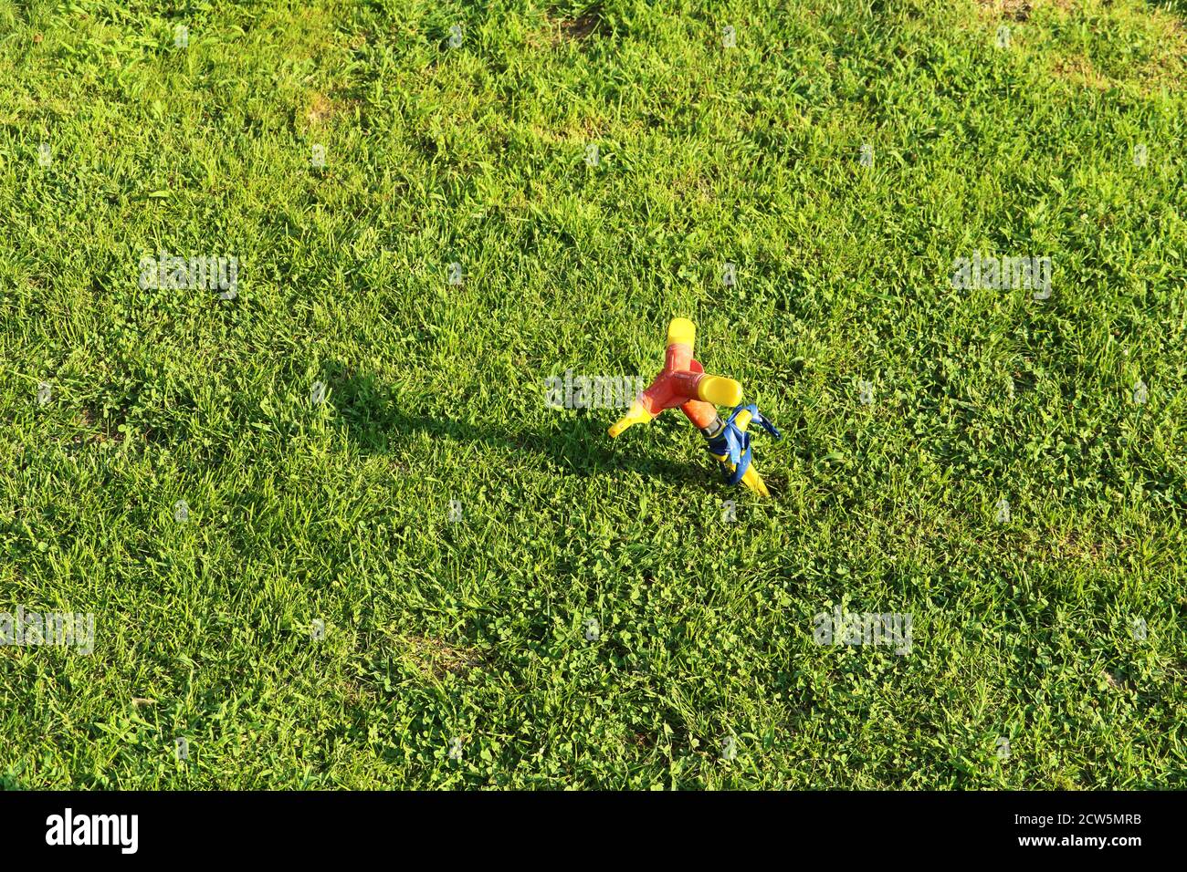 Texture of a open beach umbrella with translucent rays of blue and yel ...