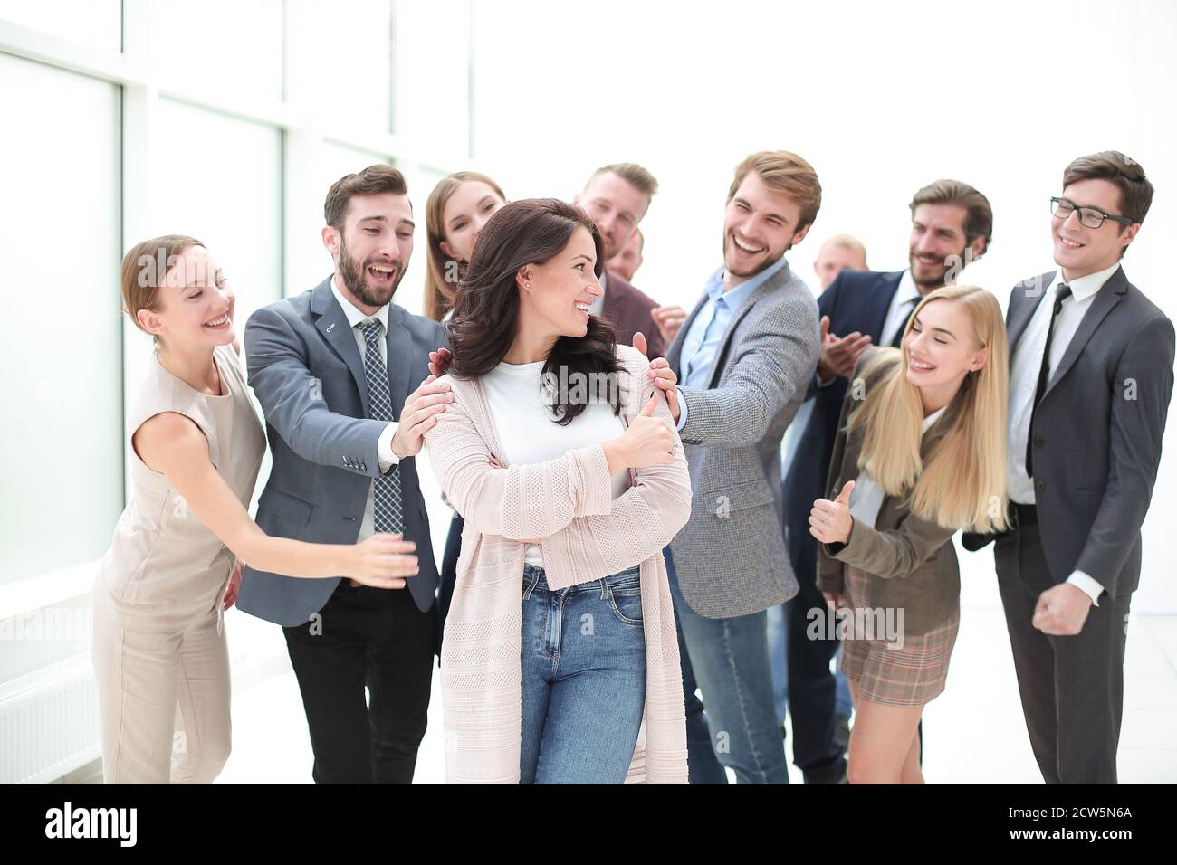 happy business team admiring their young leader Stock Photo - Alamy