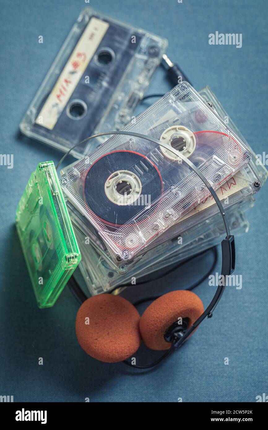 Old stack of audio cassettes with orange headphones on blue sofa Stock ...