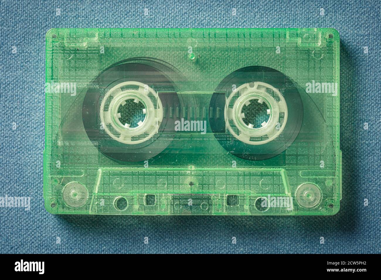 Closeup of one green audio cassettes on blue sofa Stock Photo - Alamy