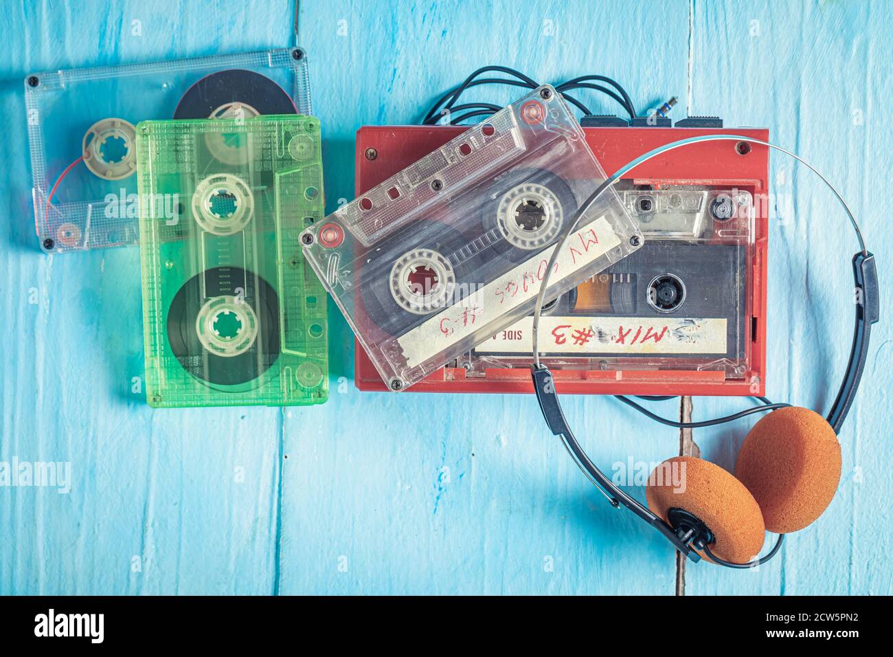 Classic cassette tape with headphones and player on blue table Stock ...