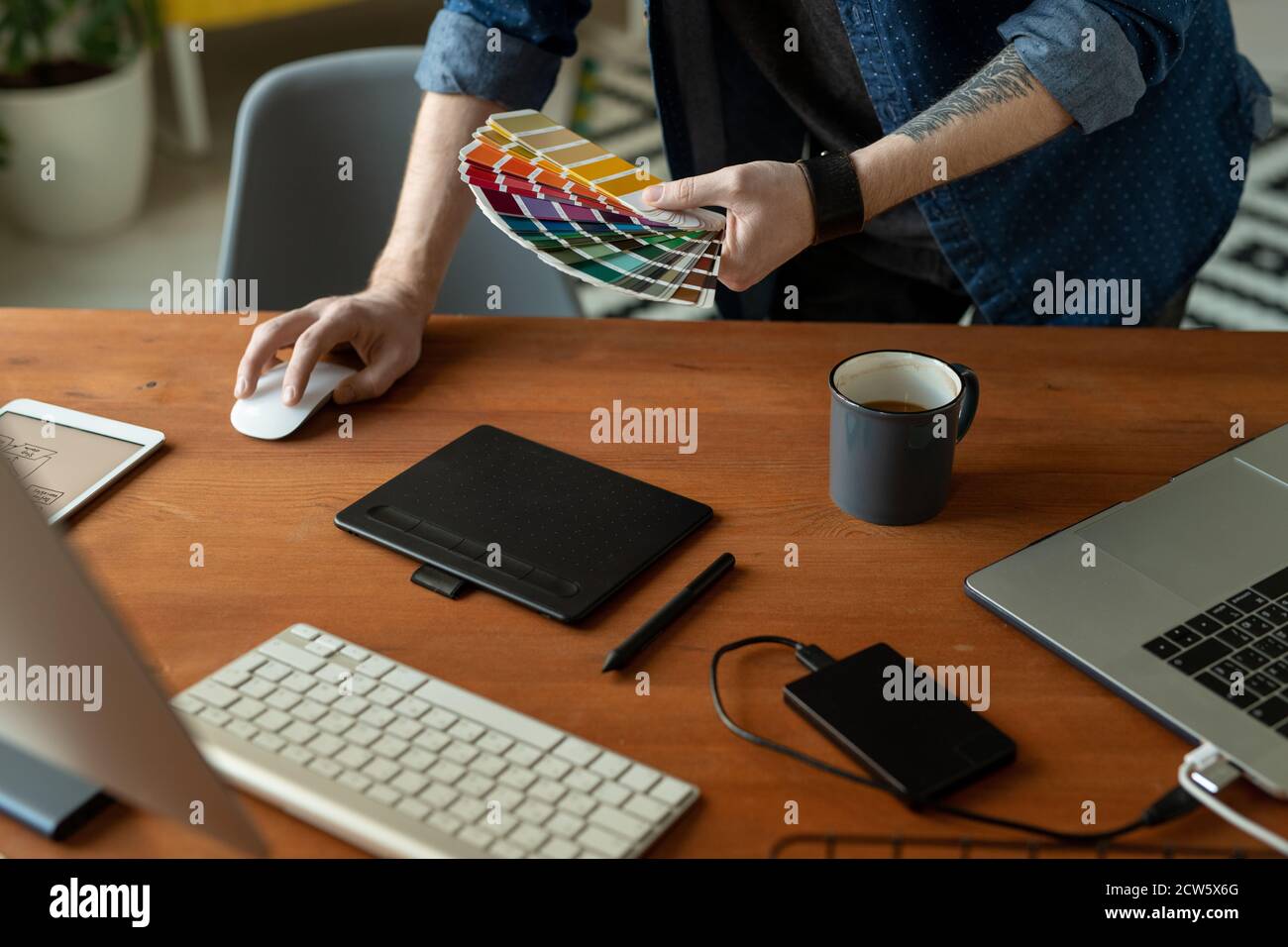 Hands of creative software developer or web designer with color palette ...