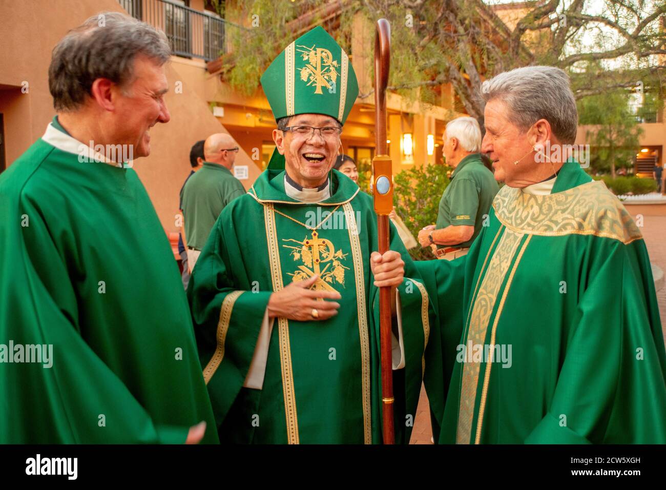Wearing green ceremonial vestments, the deacon and monsignor of a ...