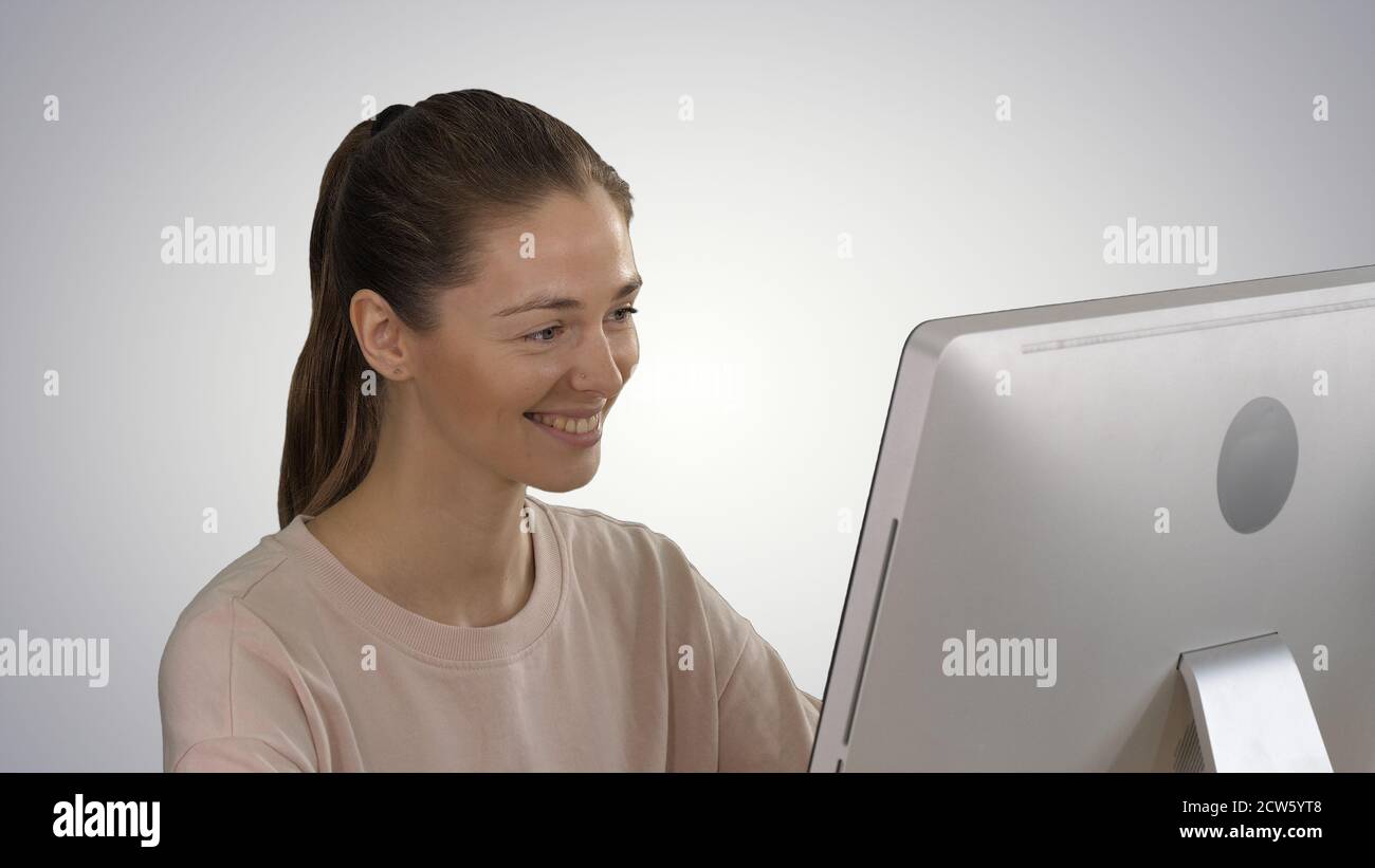 Student blonde girl looking at monitor of computer and smiling o Stock ...