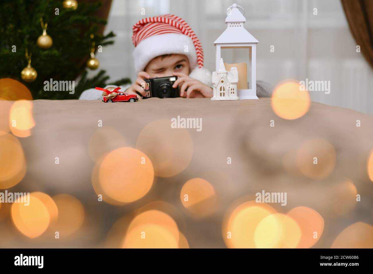 A child with no mirror automatic camera, took aim, squinting one eye ...